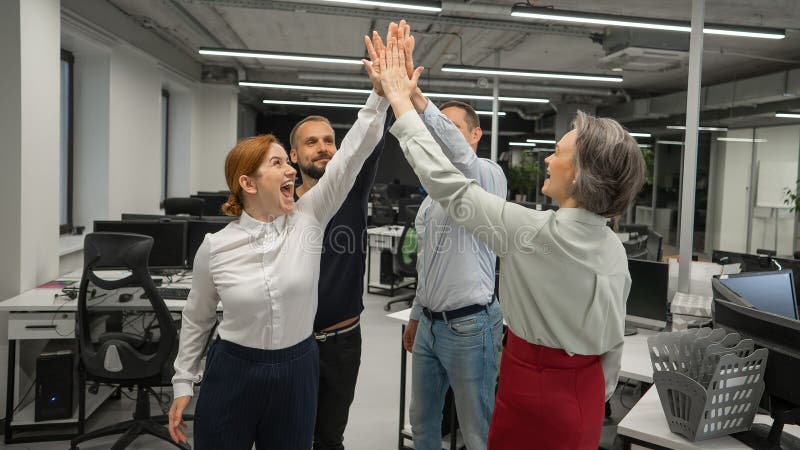 Four Co-workers Give a High Five in the Office. Stock Photo - Image of ...
