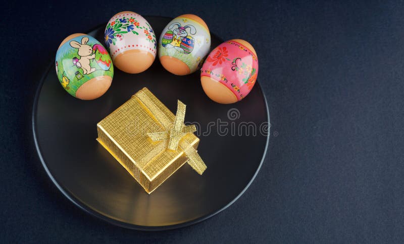Four Colored Easter Eggs and Giftbox Stock Photo - Image of copy, black ...