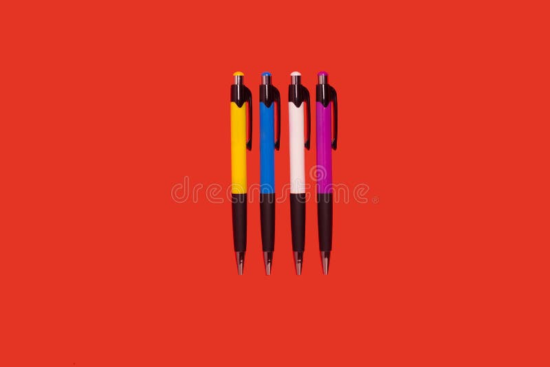 Four Colored Pens Lying on a Red Background Stock Image - Image of ...