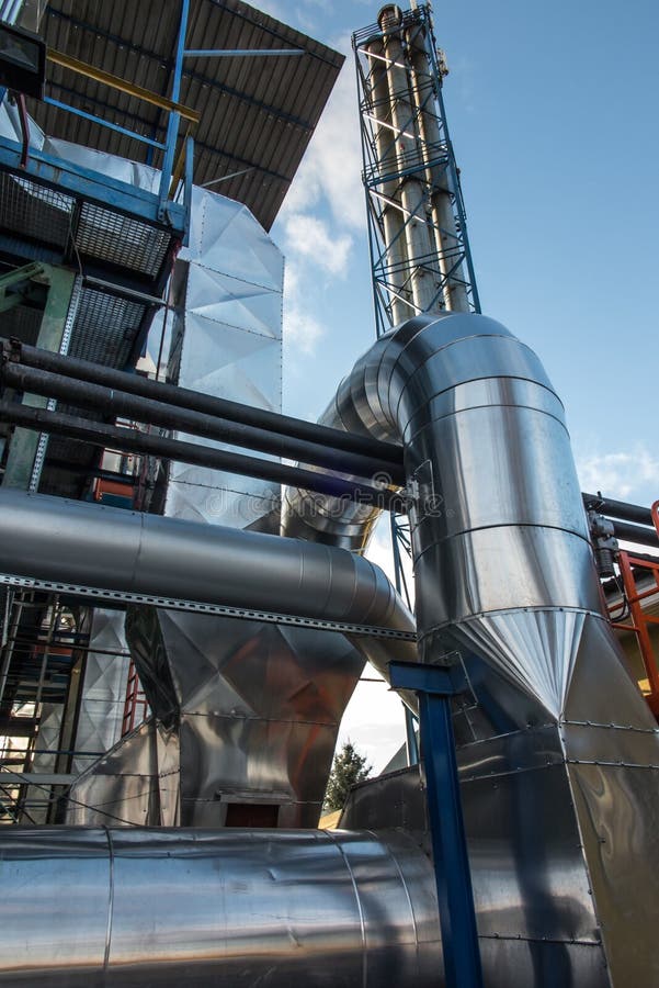 Two Metal Chimneys on the Roofs of Factory. Against Blue Sky Stock ...