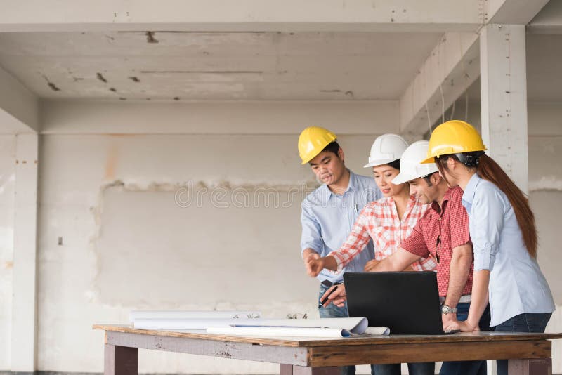 Four Construction Engineer Working in Side Building Plan for Renovation ...