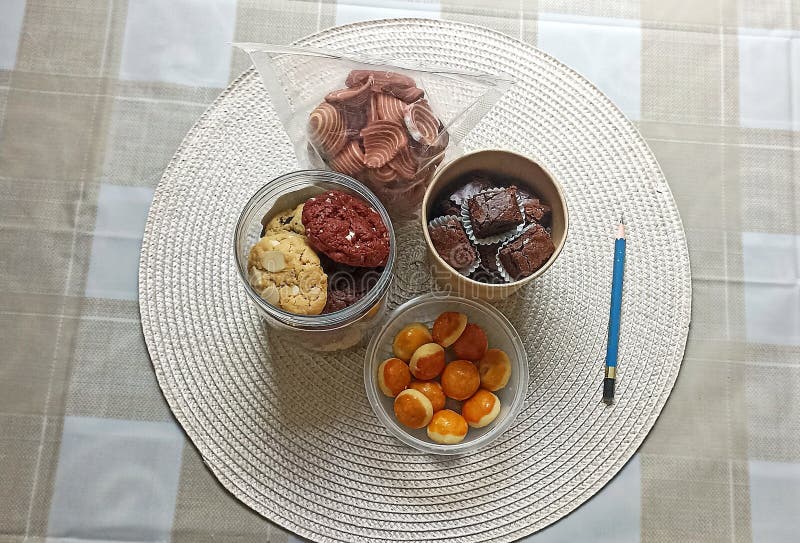 Four Containers of Various Snacks are Arranged on a Round Woven Mat ...