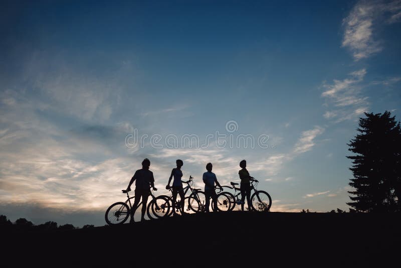 Four Cyclist on Hill at Evening Sky. Stock Image - Image of activity ...