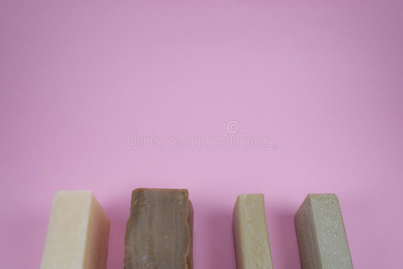 Four Different Color Soaps on Pink Background Composition Stock Image ...