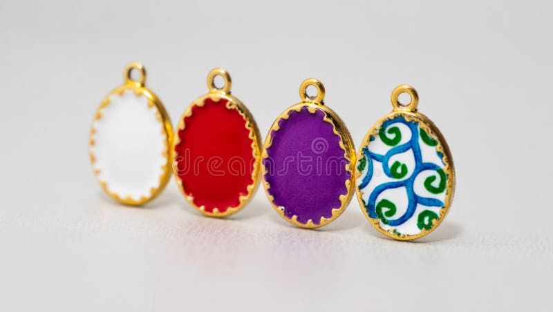 Four Different Colored Oval Shaped Charms are Displayed on a White ...