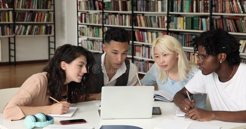 Four Diverse Students Study Remotely Using Pc in Scientific Library ...