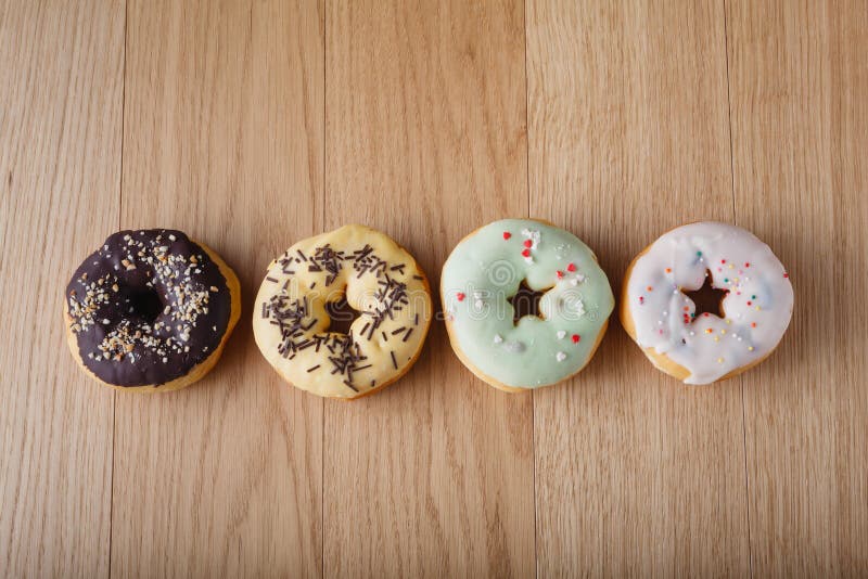 Four donuta in row stock image. Image of icing, donut - 58630251