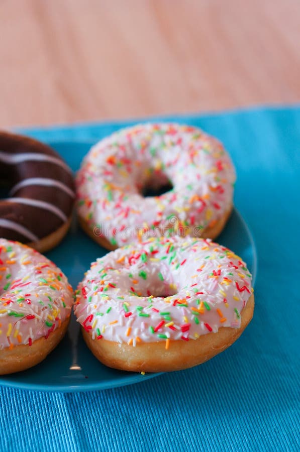 Four donuts stock image. Image of chocolate, donuts, plate - 69211503
