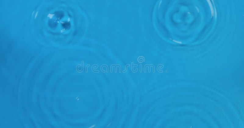 Four Drops of Rain Fall into Blue Water. Top View Stock Video - Video ...