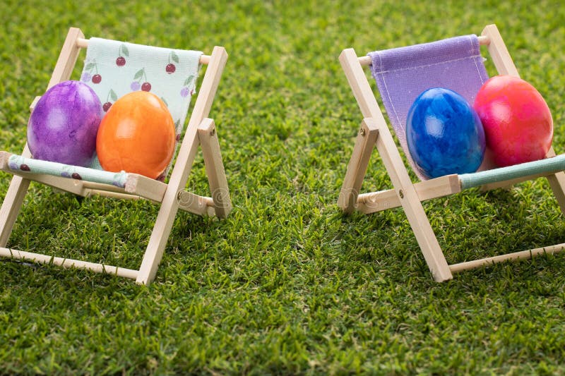 Four Easter Eggs on Two Lounge Chairs Rest in the Yard Stock Photo ...
