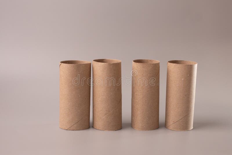 Four Empty Toilet Paper Rolls Against Grey Background Stock Photo ...