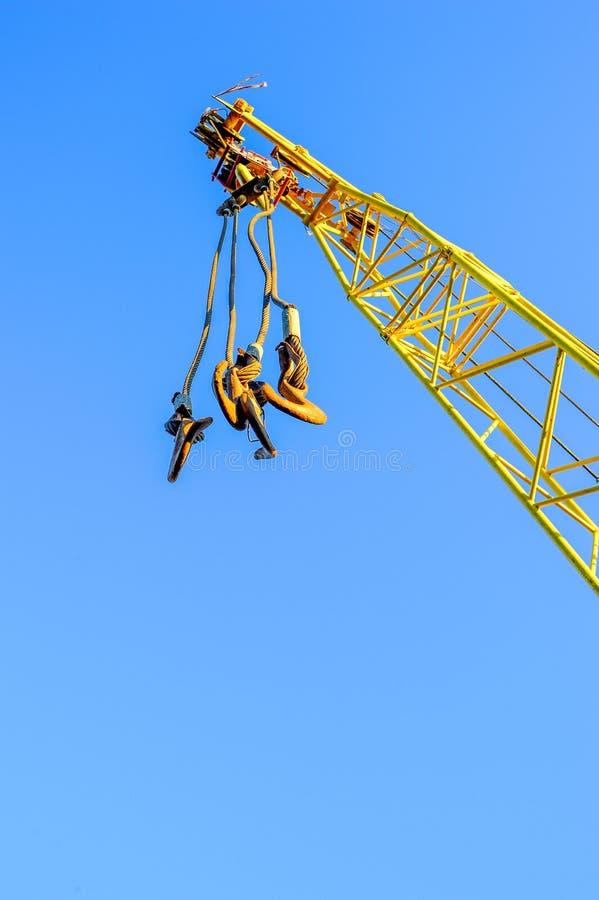 Four Empty Yellow Crane Hook Hanging Down on White Background Stock ...