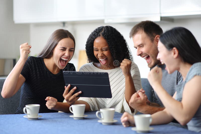 Four Excited Interracial Friends Watching Media on Tablet Stock Image ...