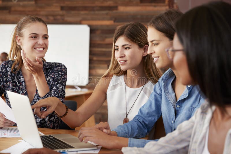 Four Female Colleagues Looking at Computer in an Office Stock Photo ...