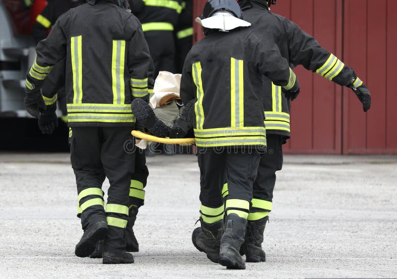 Four Firemen in Action Carry a Stretcher with Injured Stock Image ...