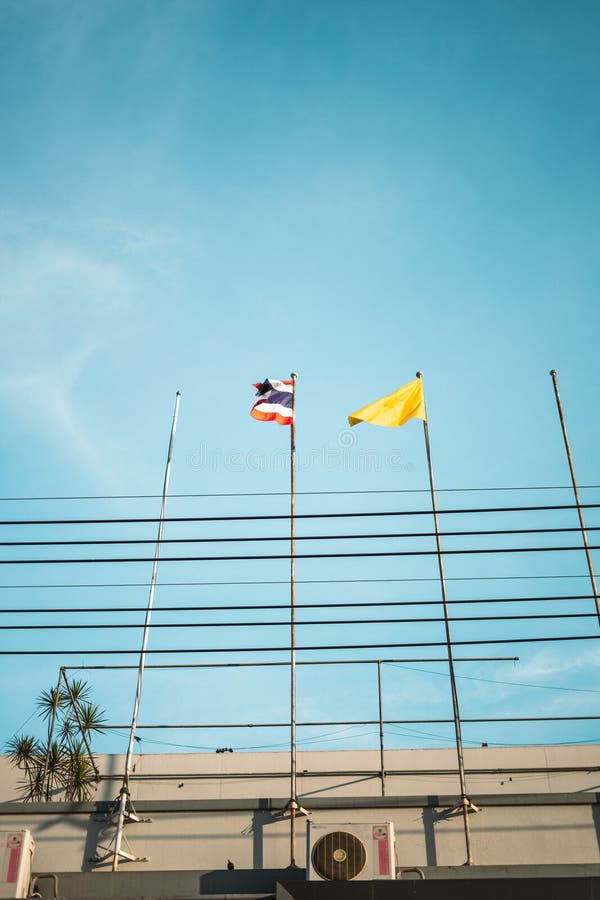 Four Flags Blowing in the Wind Next To a Building Under Construction ...