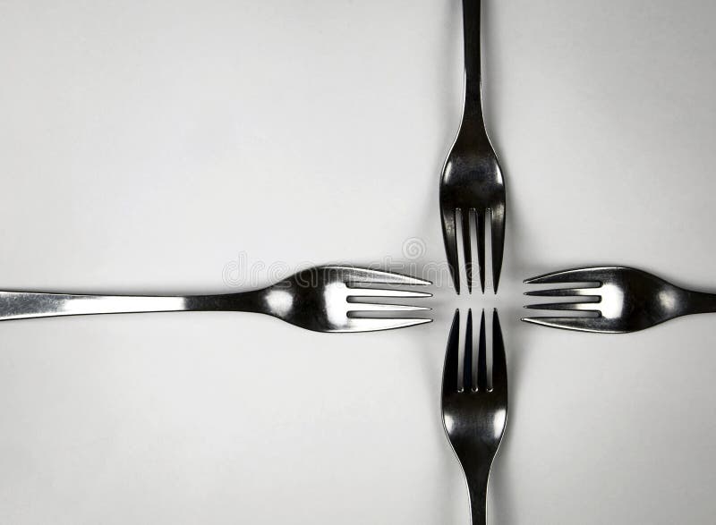 Two Forks Cross on White Surface Stock Image - Image of concept ...