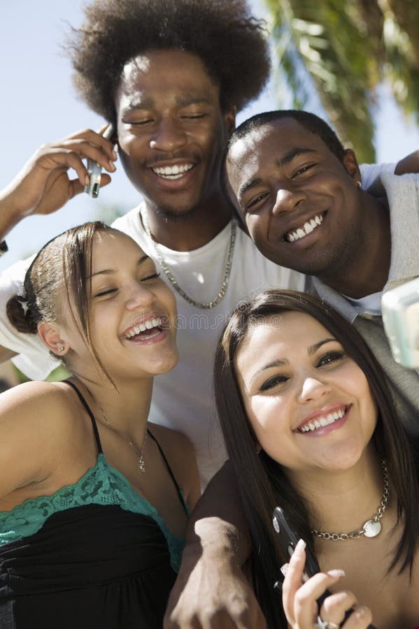 Four Friends with Mobile Phones Portrait Stock Image - Image of ...