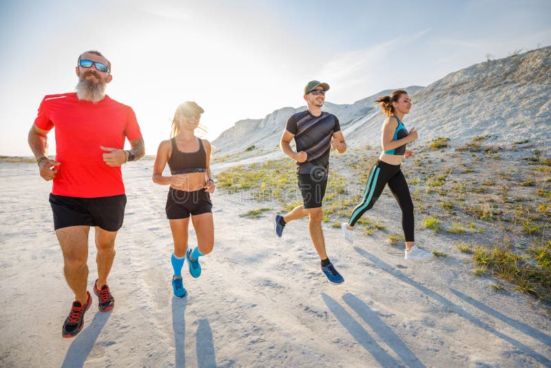 Four Friends Run Together on Trail Running Stock Photo - Image of ...