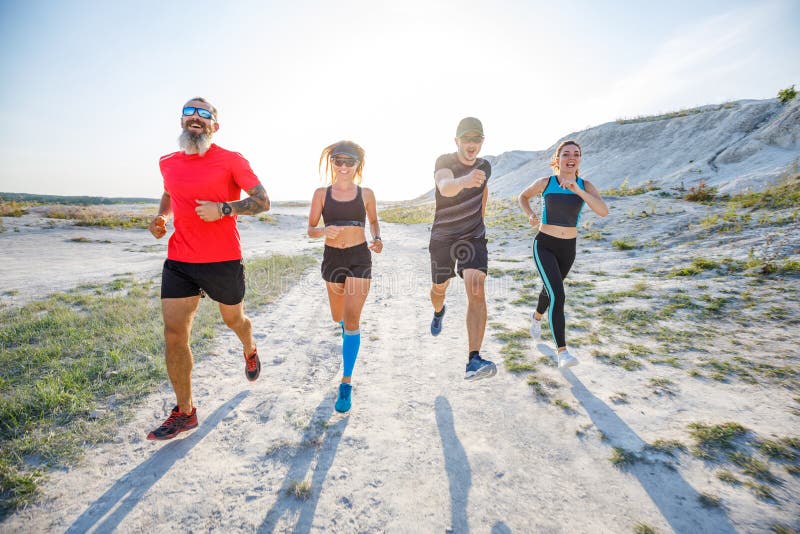 Four Friends Run Together on Trail Running Stock Image - Image of ...