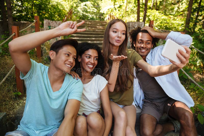Four Friends Sitting on Stairs in Forest Stock Image - Image of african ...