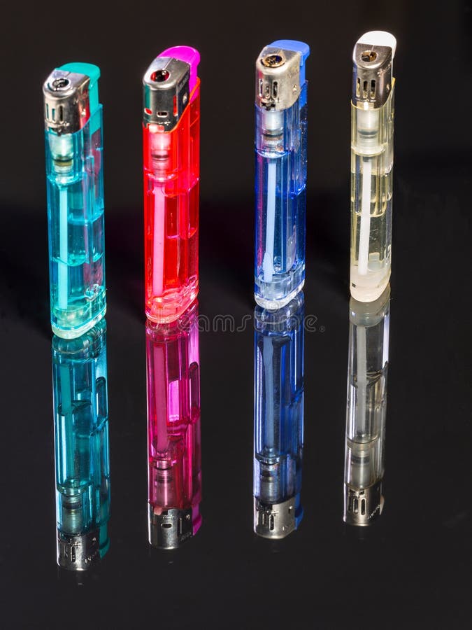 Four Gas Lighters in Different Colours on a Black Reflecting Background ...