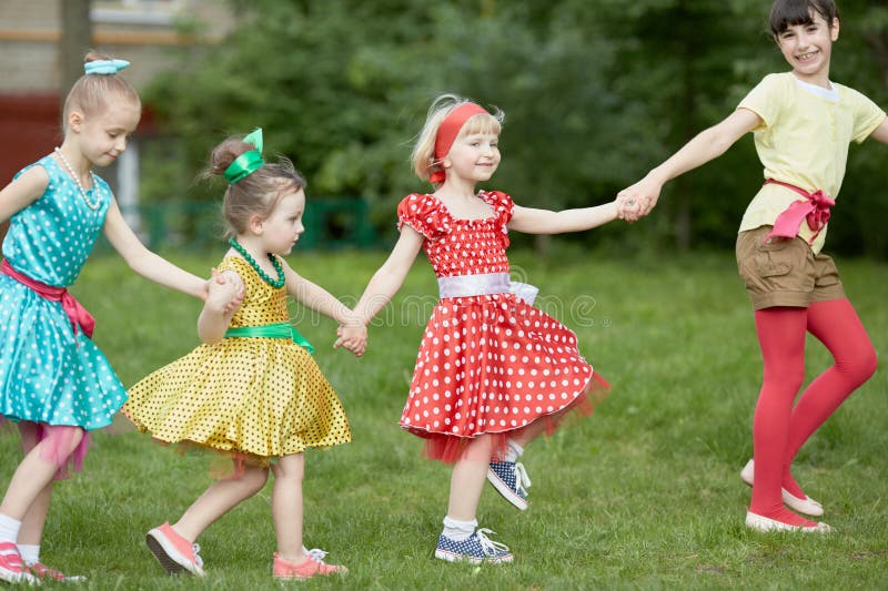 Four Girls Dance Holding Hands at Grassy Stock Image - Image of fashion ...