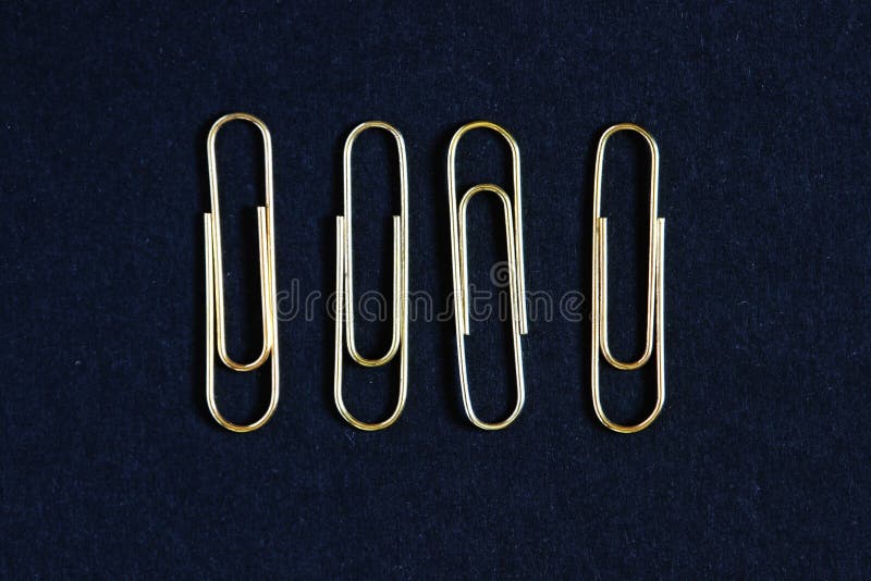 Four gold paper clips stock photo. Image of clips, tool - 103400120