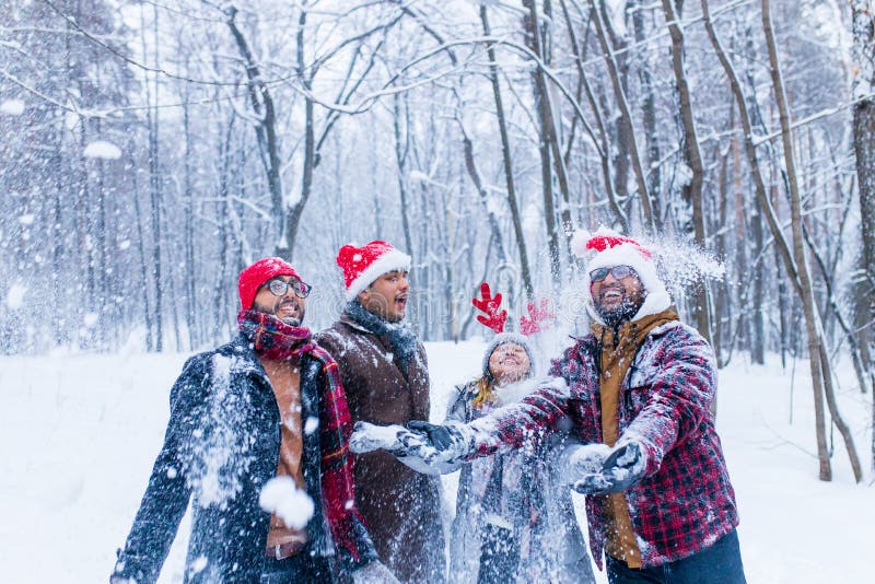 Four Happy Friends are Having Fun and Throwing Snow Stock Photo - Image ...