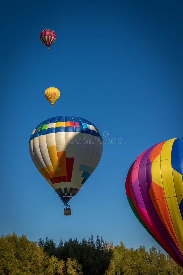 Four Hot Air Balloons in a Line Flying at Different Altitudes Editorial ...