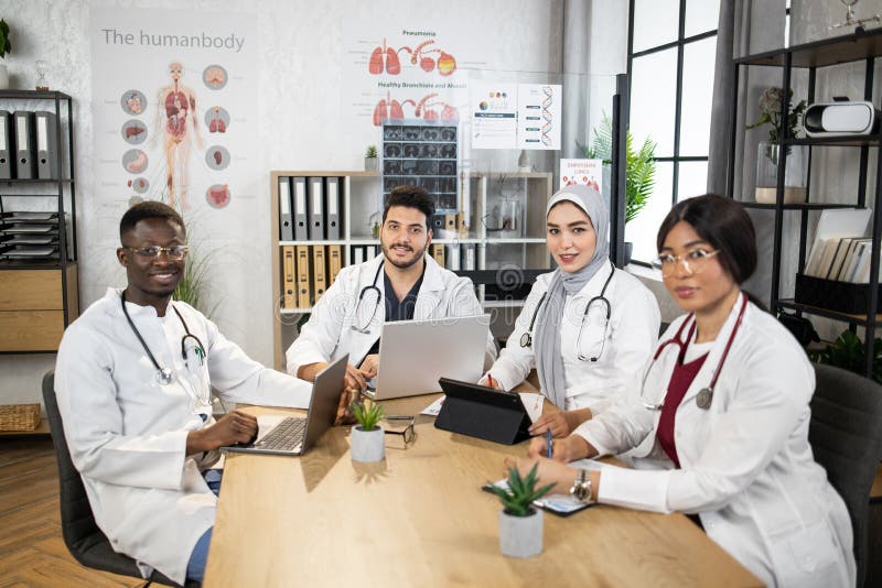 Four International Doctors with Gadgets at Office Stock Image - Image ...
