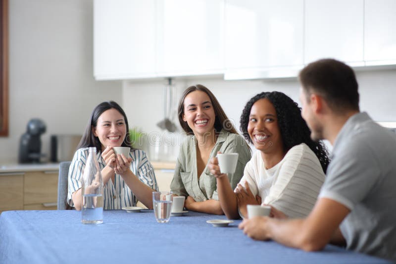 Four Interracial Friends at Home Talking Drinking Coffee Stock Photo ...