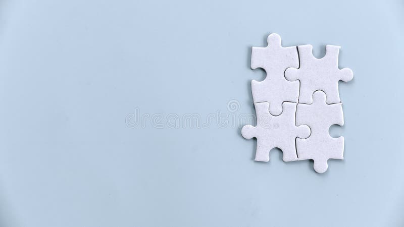 Four Jigsaw Puzzle Pieces Interlocking: Symbolizing Teamwork and ...