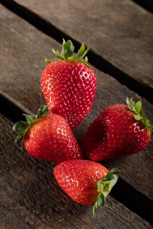 Four Juicy Strawberry on Wooden Plank Stock Image - Image of closeup ...
