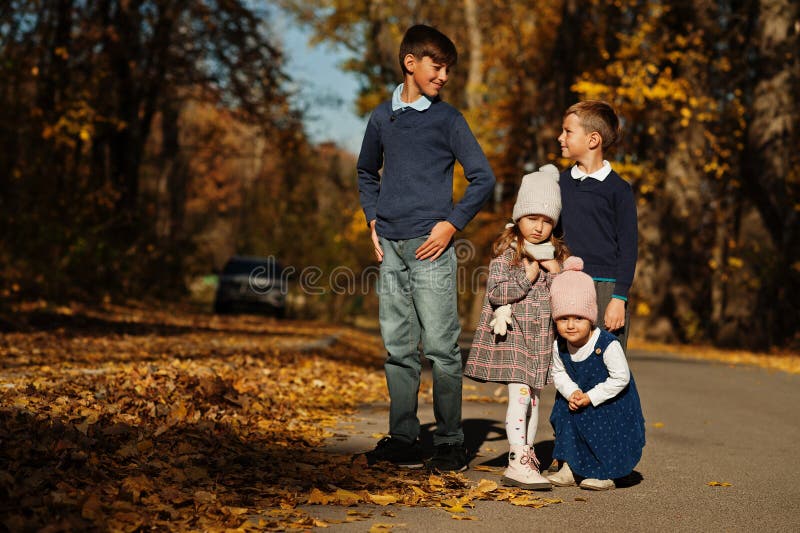 Four Kids Posing at Autumn Fall Park Stock Image - Image of posing ...