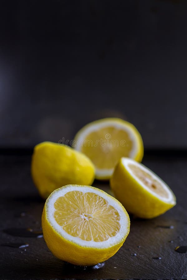 Four Lemons on Black Stone stock image. Image of juicy - 63772197