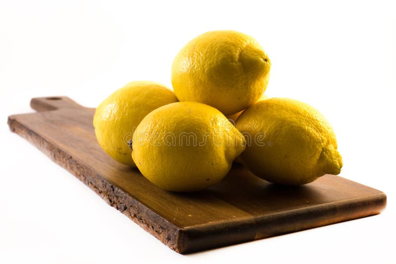 Four Lemons on a Wooden Board on White Background Stock Photo - Image ...