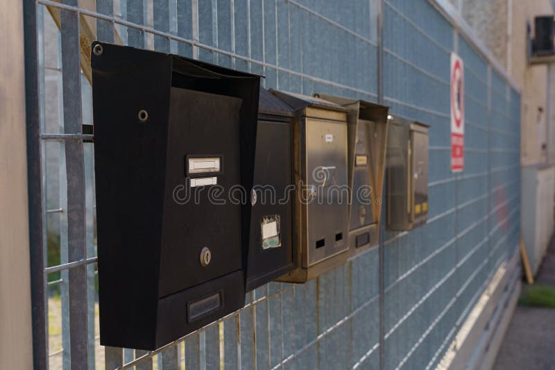 A Row of Mailboxes on a Blue Gate in a City Neighborhood Stock Image ...
