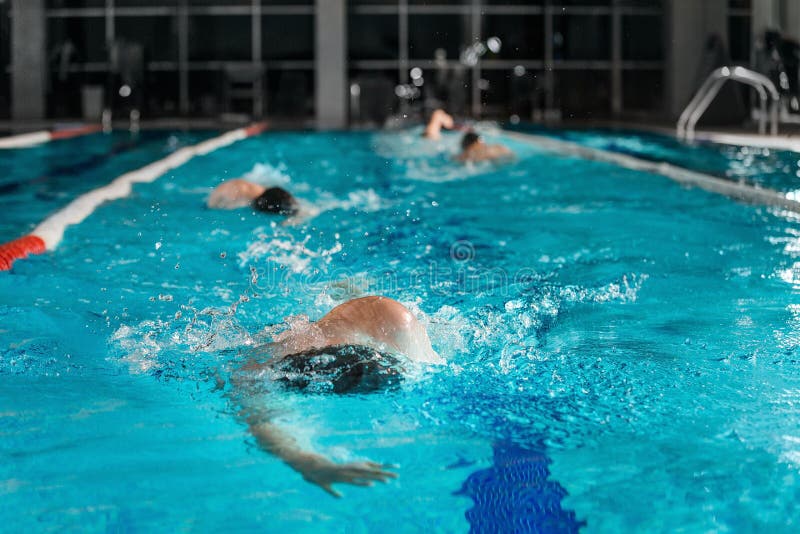 Four Male Swimmers Swimming in the Same Lane Stock Photo - Image of ...