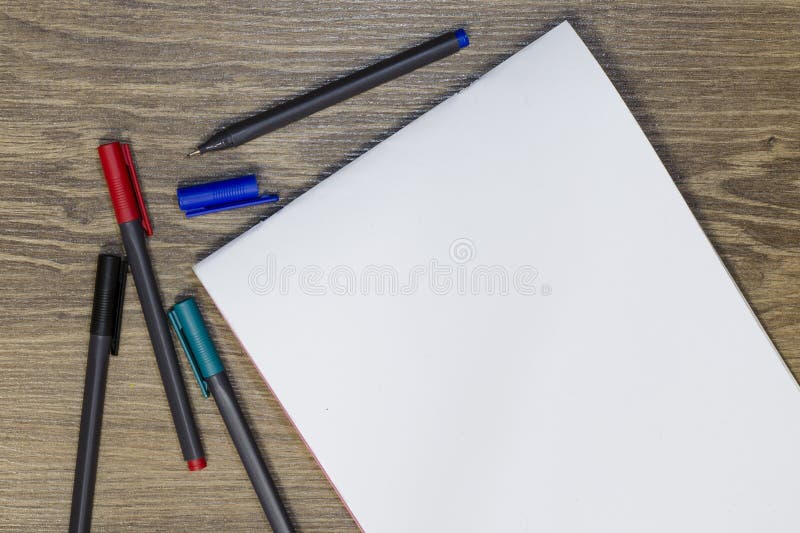 Four Markers and a White Sheet of Paper on the Table Stock Photo ...