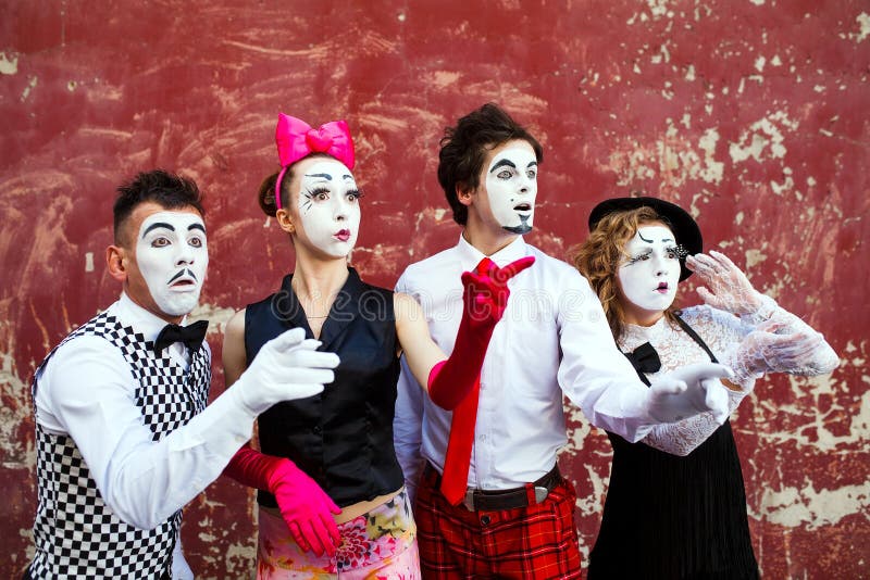 Four Mimes Looking Aside on the Background of a Red Wall Stock Image ...