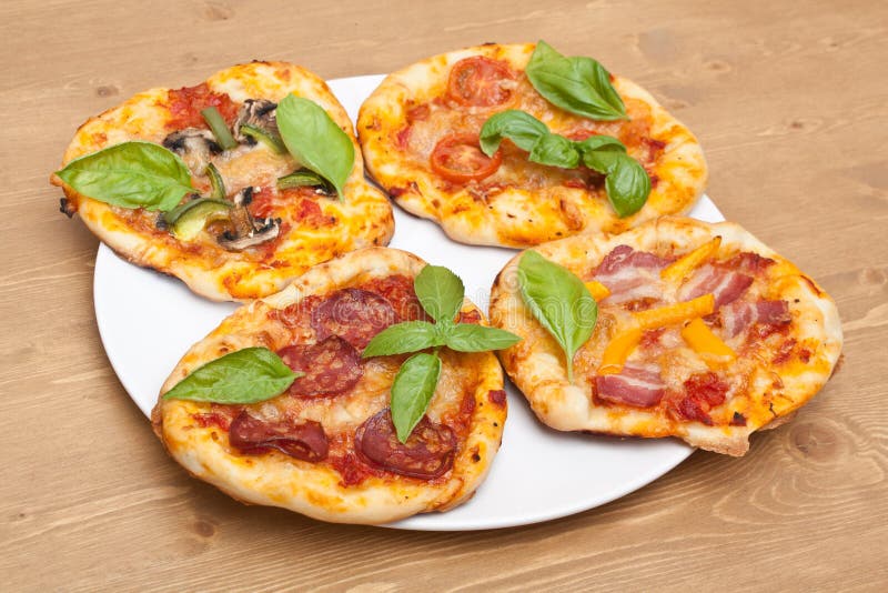 Four Mini Pizzas stock photo. Image of cutting, junk - 42619634