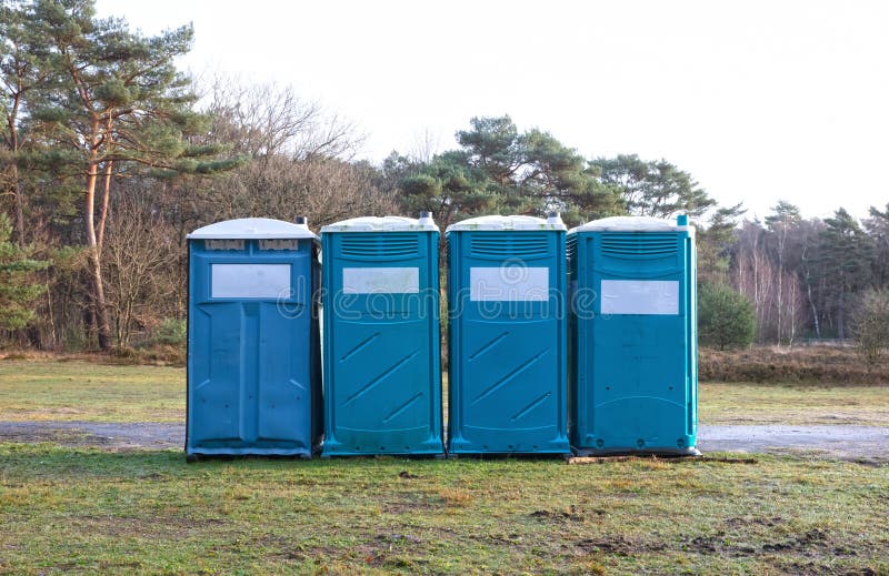 Four Mobile Toilets on a Row Stock Photo - Image of grass, toilet ...