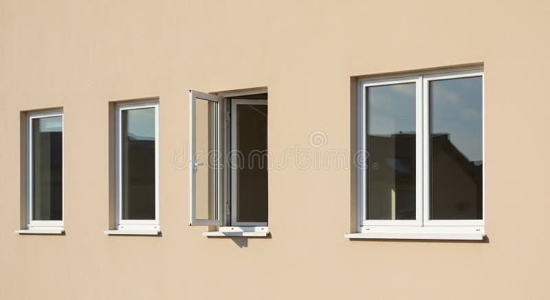 Four Modern, Rectangular Windows with White Frames are Set in a Smooth ...