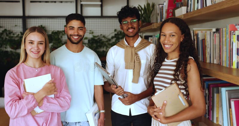 Four Multi-ethnic Students Posing for Camera in University Library ...