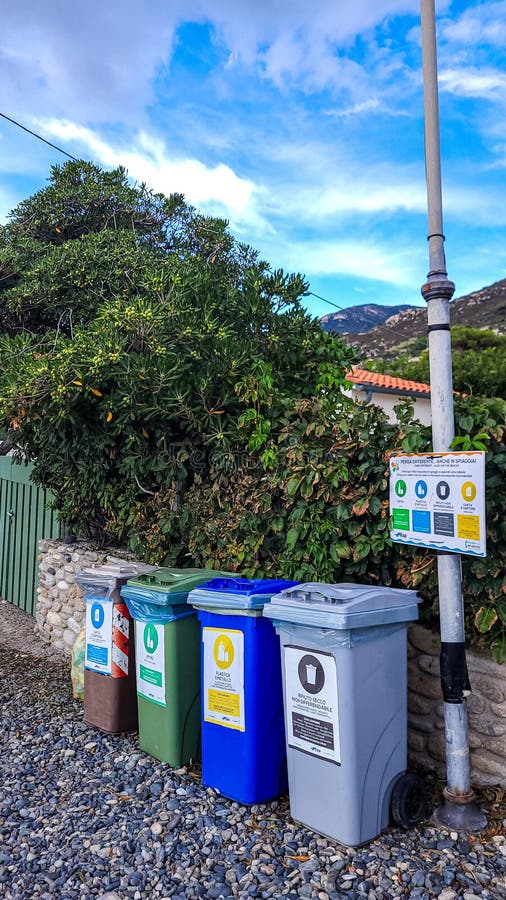Four Multicolored Garbage Sorting Containers in the Beach Against the ...