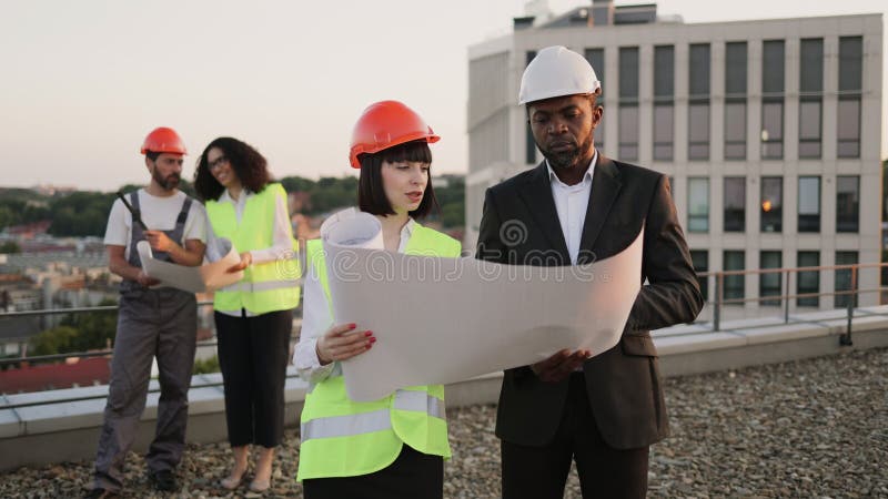 Four Multiethnic Engineers Discussing Construction Process Stock ...