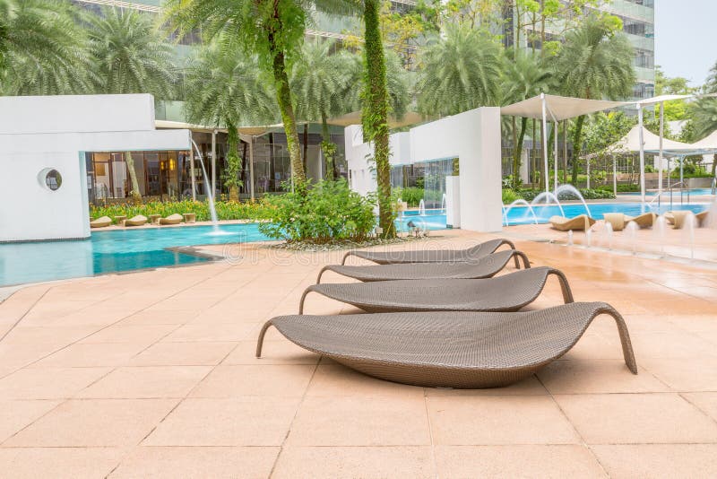 Four Nice Leaf-like Resting Chairs by Beautiful Pool Stock Photo ...