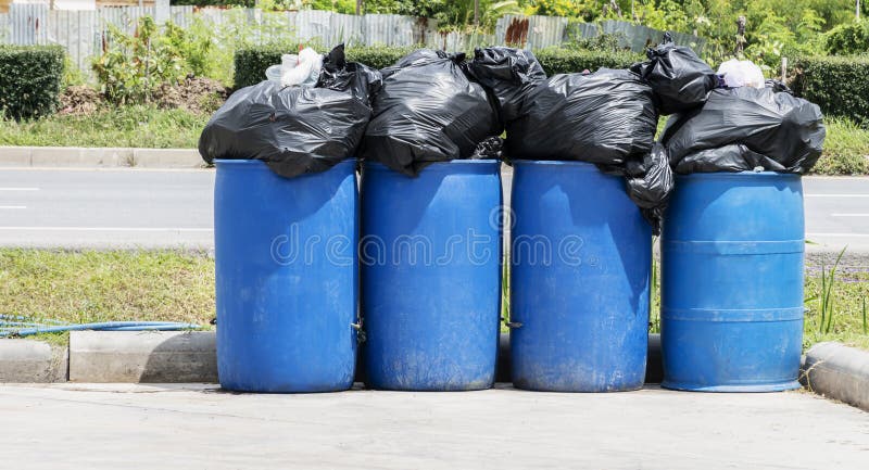 Four Old Blue Garbage Bin with Garbage Bags on Footpath Stock Image ...