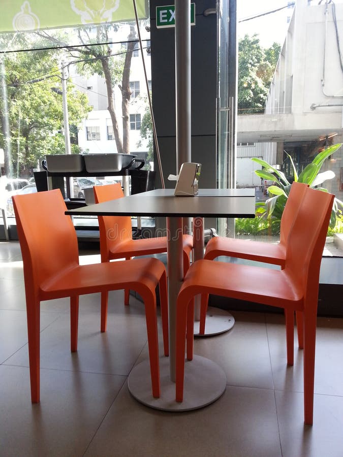Four Orange Chairs with a Dinning Table Stock Image - Image of break ...